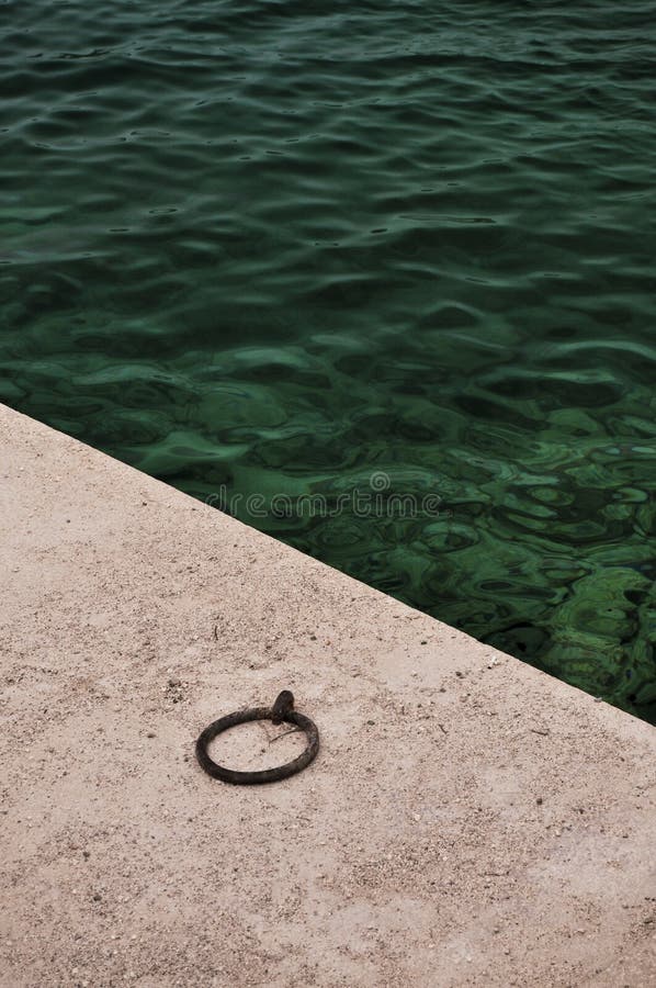 Metal Ring Mooring Post on Concrete Stock Image - Image of moor ...