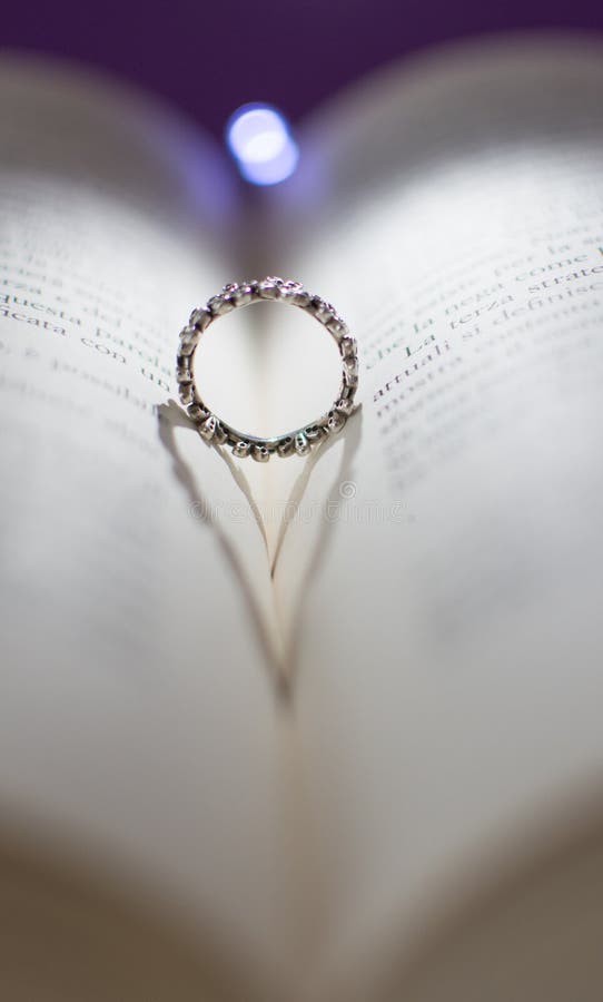 Ring between the Pages of a Book that Projects a Shadow in the Shape of ...