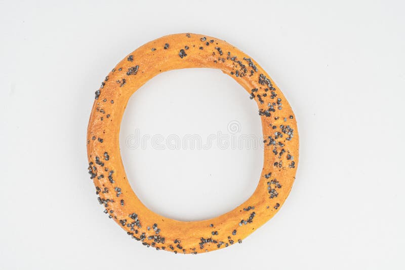 A Ring-shaped, Textured Donut with Seeds, Set Against a Plain ...