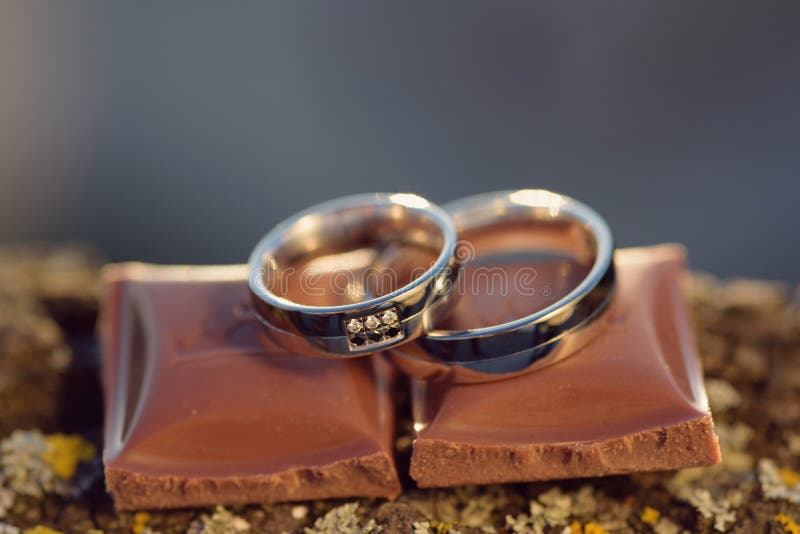 Rings on Chocolate Pieces stock photo. Image of engagement - 47506222