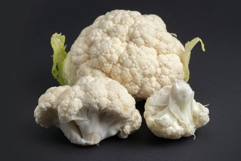 Ripe Cauliflower with Green Leaves on Dark Background Stock Photo ...