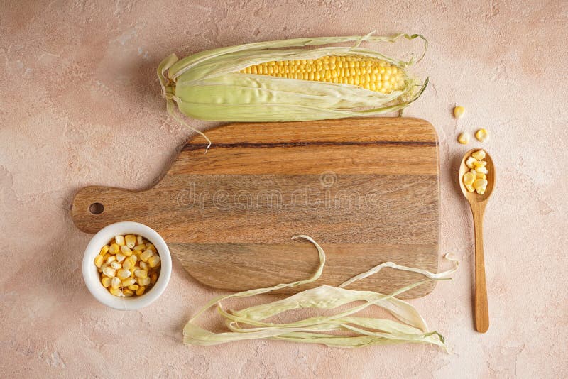 Ripe Corn on a Cutting Board on a Beige Background, Top View Stock ...