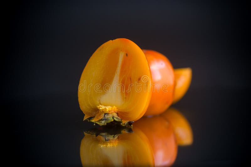 Ripe Cut Half Persimmon Isolated on Black Stock Image - Image of close ...