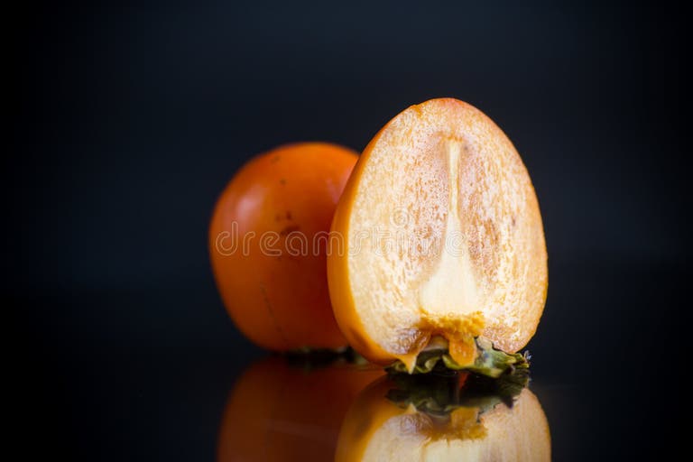 Ripe Cut Half Persimmon Isolated on Black Stock Photo - Image of ...