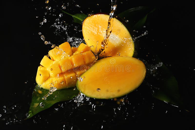 Ripe Cut Mango with Water Splash on Dark Background Stock Photo - Image ...