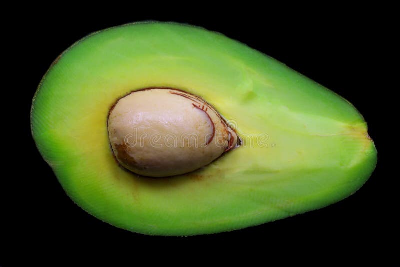 Ripe Green Avocado Halved with Large Seed Inside on Black Stock Photo ...
