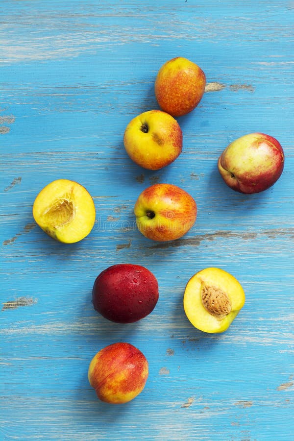 Ripe Juicy Nectarines Over Blue Wooden Table Stock Image - Image of ...