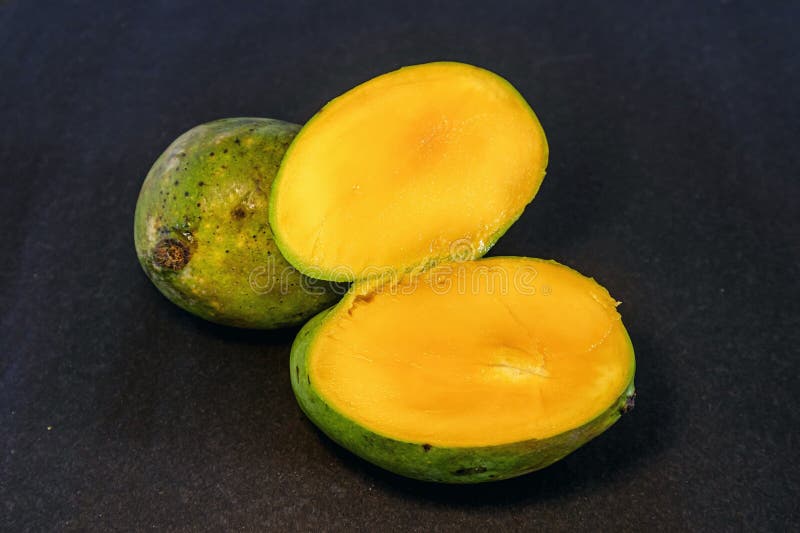 Ripe Local Indonesian Mango with Cut in Half Isolated on Dark ...