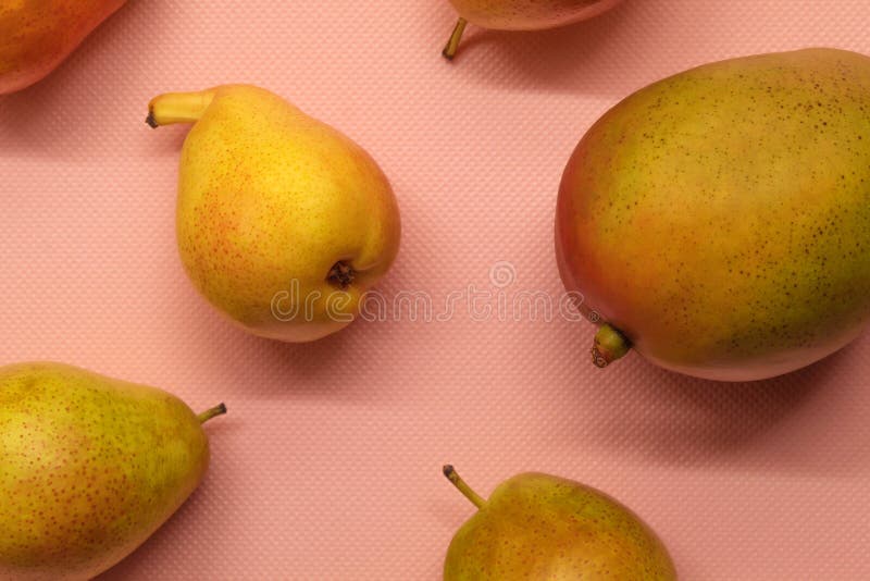 Ripe Mango on the Side and Yellow Pears in the Center on a Pink ...