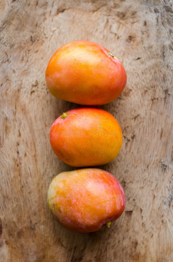 Ripe mangoes on a table stock image. Image of table - 127257903