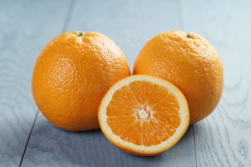 Ripe Oranges with Half Sliced on Blue Wood Table Stock Image - Image of ...