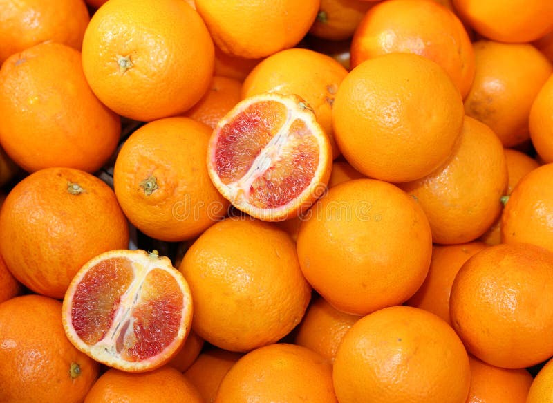 Ripe Oranges and an Orange Cut in the Stall of Greengrocer Stock Image ...