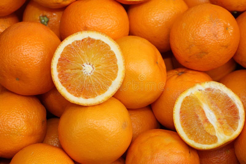 Ripe Oranges and an Orange Cut in the Stall of Greengrocer Stock Image ...