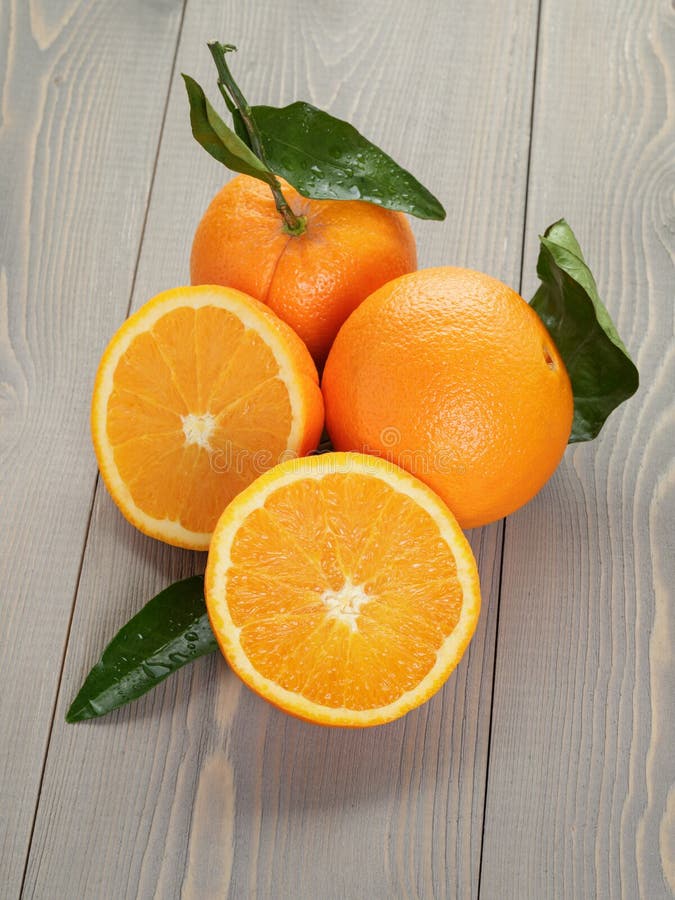 Ripe Oranges on Wooden Table Stock Image - Image of slice, green: 39457497