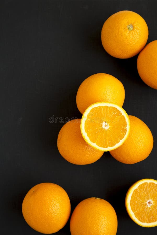 Ripe Organic Oranges on a Black Surface, Top View. Flat Lay, Overhead ...