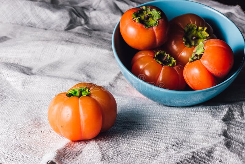Ripe Persimmons in Bowl stock image. Image of antioxidant - 81035921