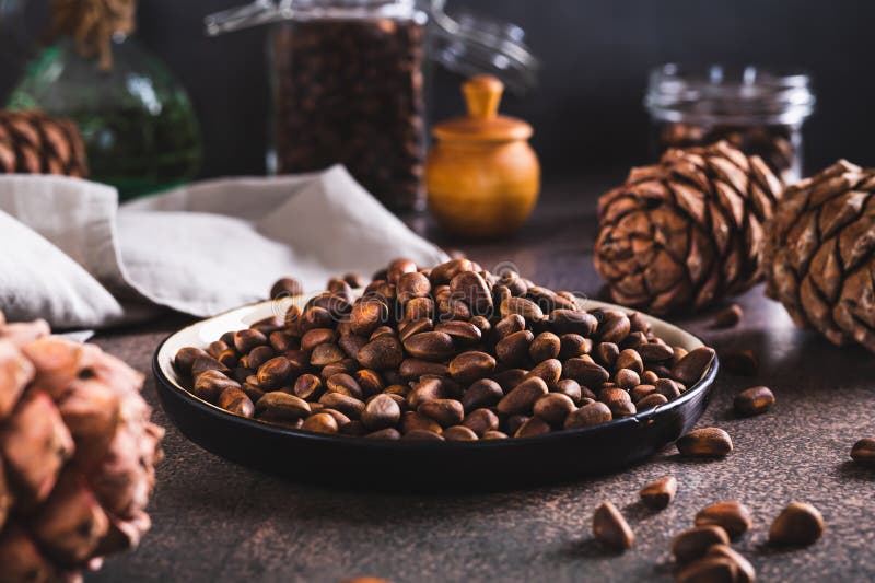 Ripe Pine Nuts in the Shells on a Plate and Boiled Pine Cones on the ...