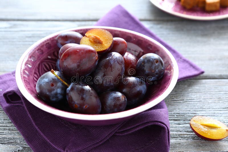 Ripe plum in a small bowl stock photo. Image of blue - 44481994