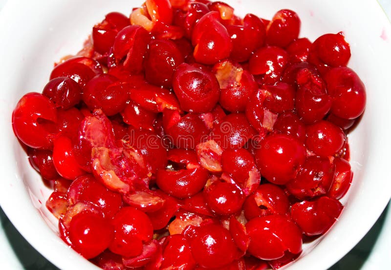 Ripe Red Cherry Berries in a Plate with Picked-out Pits. Cherries ...