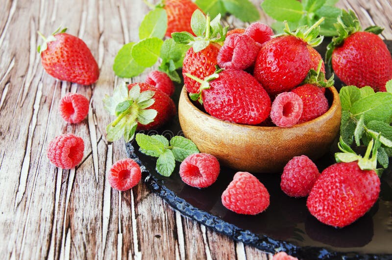 Ripe Red Raspberries and Strawberries in Wooden Bowl, Selective Focus ...