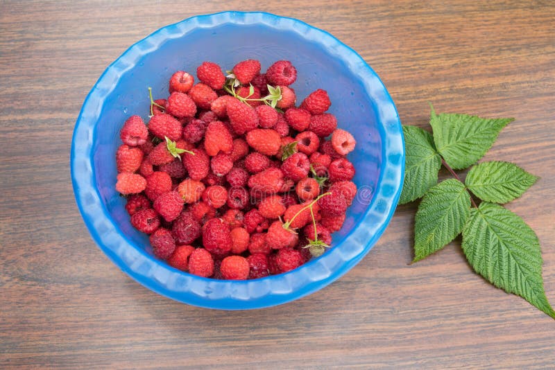 Ripe Red Raspberry Background with Green Leaves Stock Photo - Image of ...