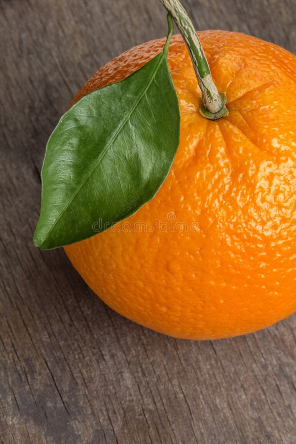 Ripe Round Orange with Stem and Leaf on Wooden Table Stock Photo ...