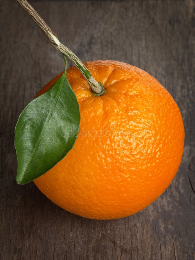 Ripe Round Orange with Stem and Leaf on Wooden Table Stock Photo ...