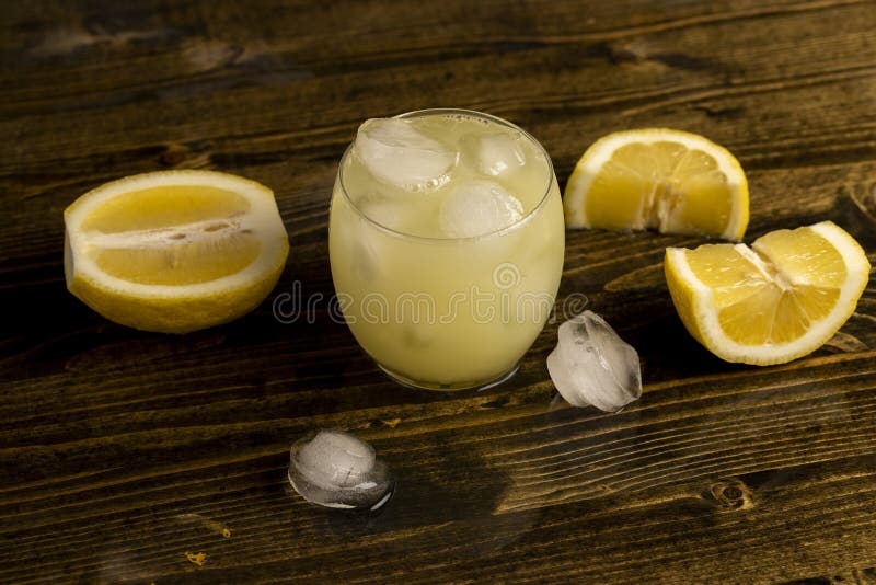 Ripe Sliced Lemon and Cold Juice with Ice and Their Reflection on a Wet ...