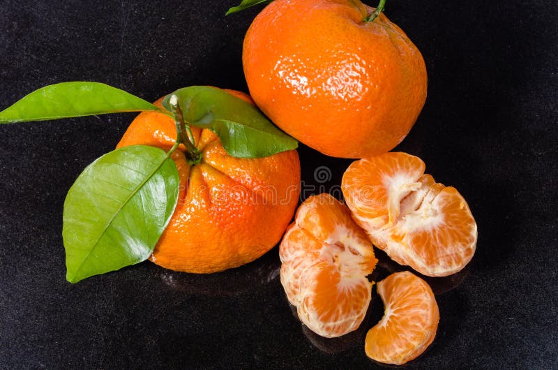 Ripe Tangelos with Leaves on Black Counter Stock Photo - Image of ...