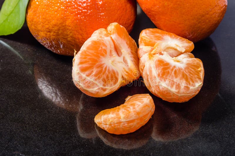 Ripe Tangelos with Leaves on Black Counter Stock Photo - Image of leaf ...