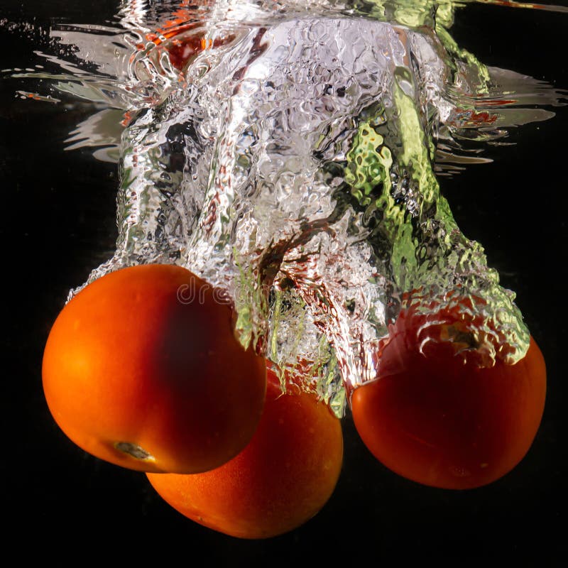 Ripe Tomato Falls Deeply Under Water with a Big Splash Stock Photo ...