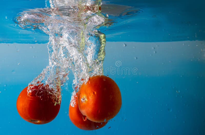 Ripe Tomato Falls Deeply Under Water with a Big Splash Stock Image ...