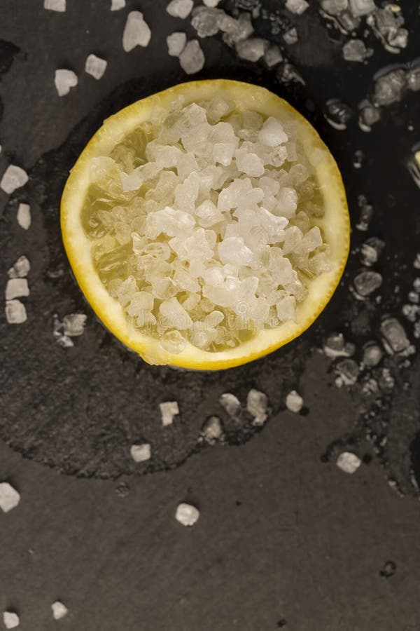 Ripe Yellow Lemon and Salt on a Black Board Stock Photo - Image of ...
