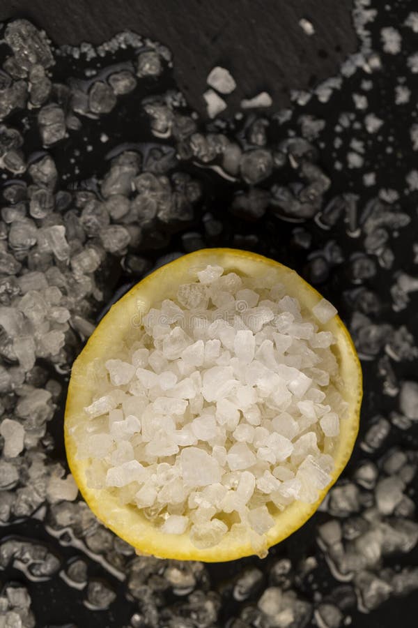Ripe Yellow Lemon and Salt on a Black Board Stock Image - Image of ...