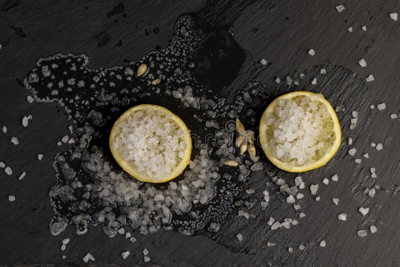 Ripe Yellow Lemon and Salt on a Black Board Stock Image - Image of ...