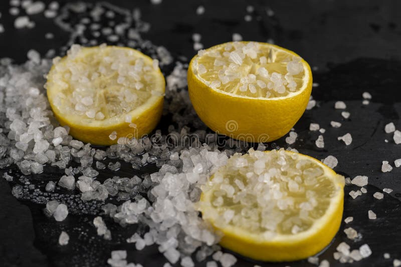 Ripe Yellow Lemon and Salt on a Black Board Stock Image - Image of ...
