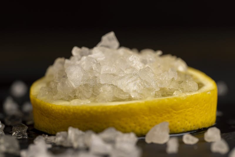 Ripe Yellow Lemon and Salt on a Black Board Stock Image - Image of ...