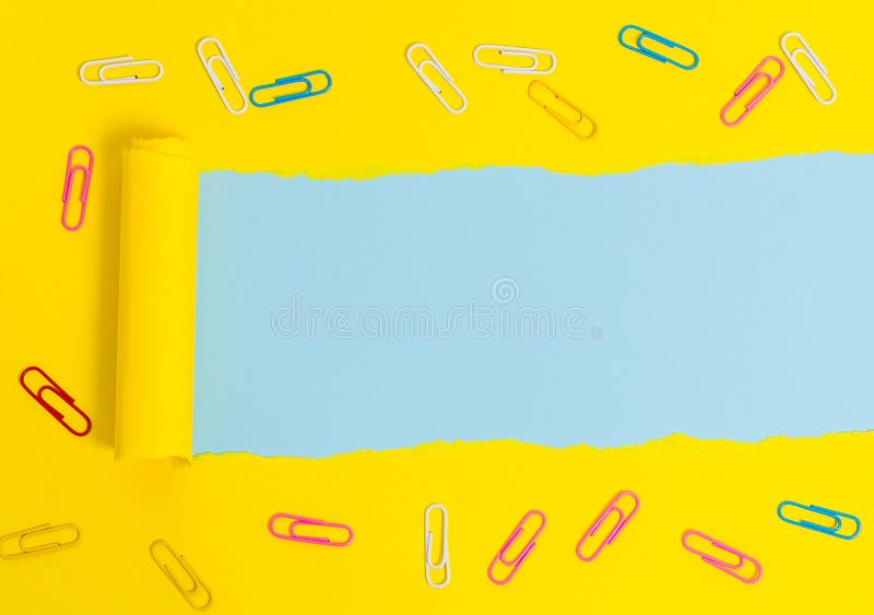 Ripped Cardboard with Paper Clip Placed Above a Soft Colour Table ...