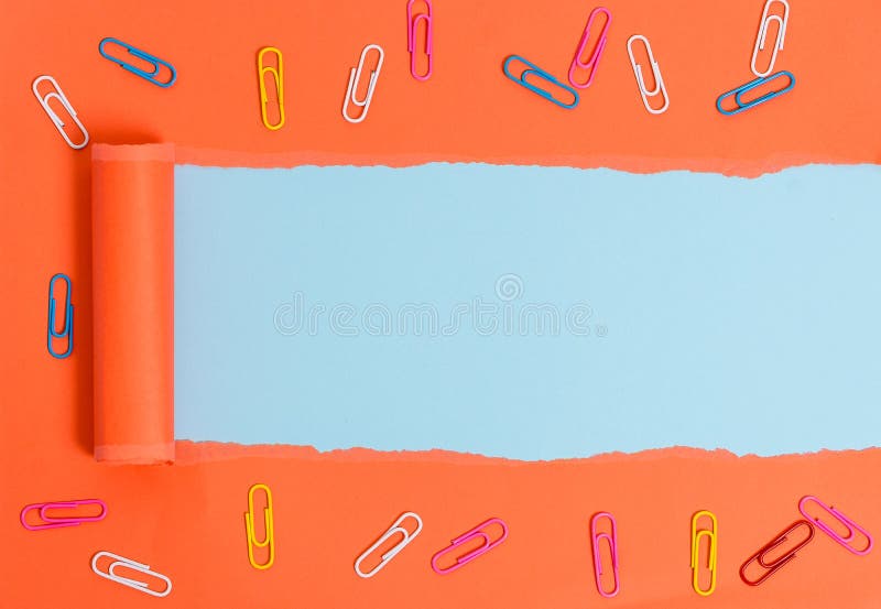 Ripped Cardboard with Paper Clip Placed Above a Soft Colour Table ...