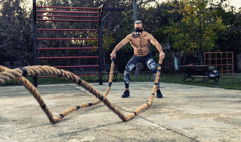 Ripped Handsome Guy Working Out with Battle Ropes while Wearing a ...