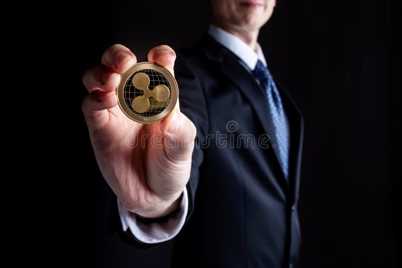 Ripple Cryptocurrency Coin Held with a Man in a Suit Stock Photo ...