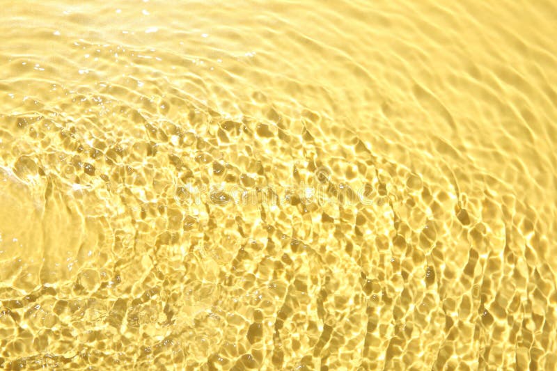 Rippled Surface of Clear Water on Yellow Background, Closeup Stock ...
