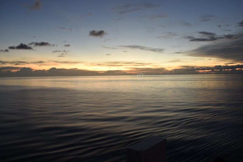 Rippled Water of the Ocean with Sundown Textured Sky Stock Photo ...