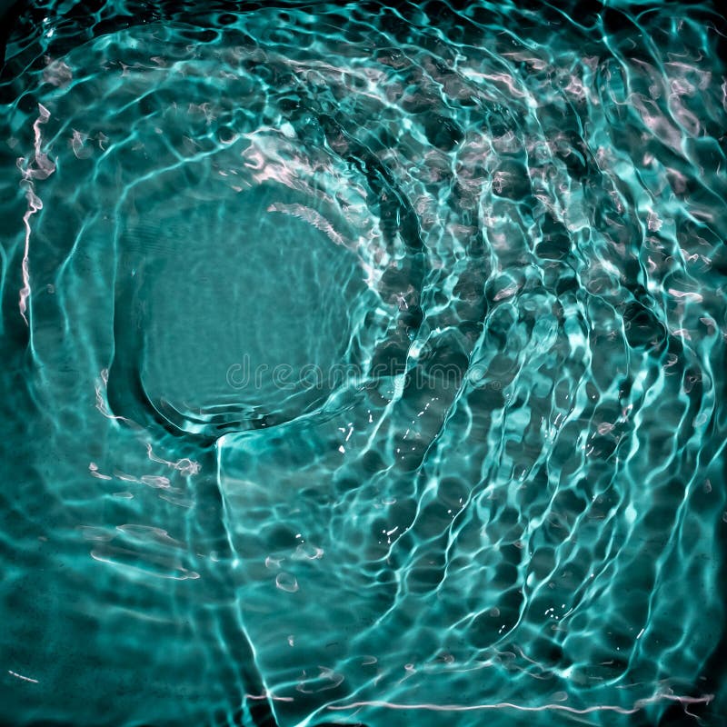 A Freeze Frame of Water on a Blue Background, with Ripples Spreading ...