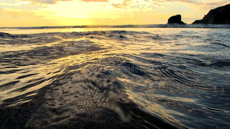 Evening waves at sundown stock photo. Image of cloud - 220330014