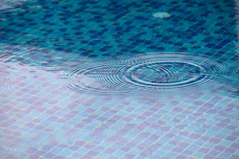 Rippling Patterns Form on the Tranquil Surface of a Blue-tiled Pool on ...