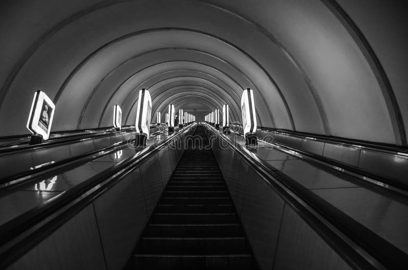 Rise on the Escalator in the Subway. Light Boxes Along the Tunnel Stock ...