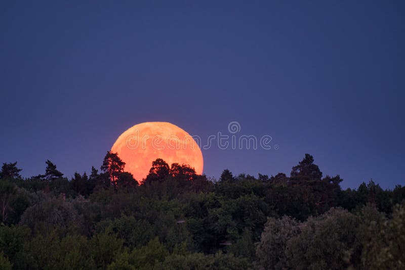 The rising of the red moon stock image. Image of sunlight - 246309667