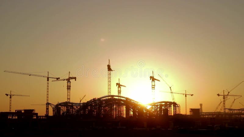 The Rising Sun Appears from Behind a Silhouette Building of the ...