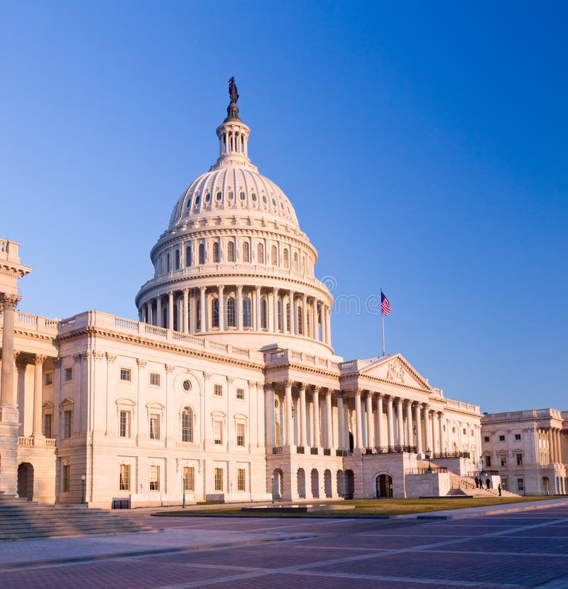 Rising Sun Illuminates the Capitol Stock Image - Image of flag, sunrise ...